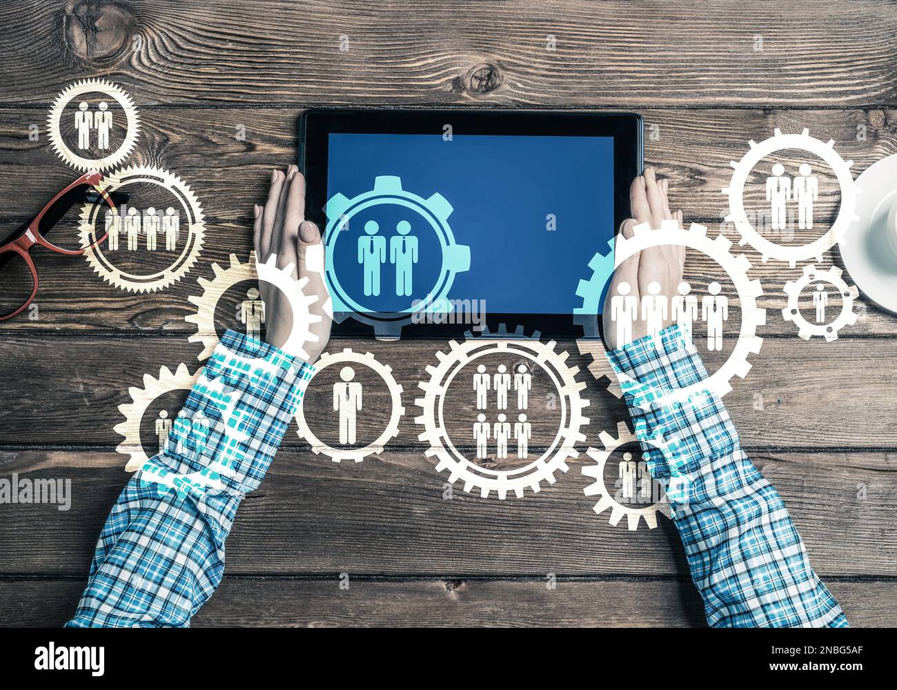 Concept of teamworking and connection with gears mechanism and tablet ...