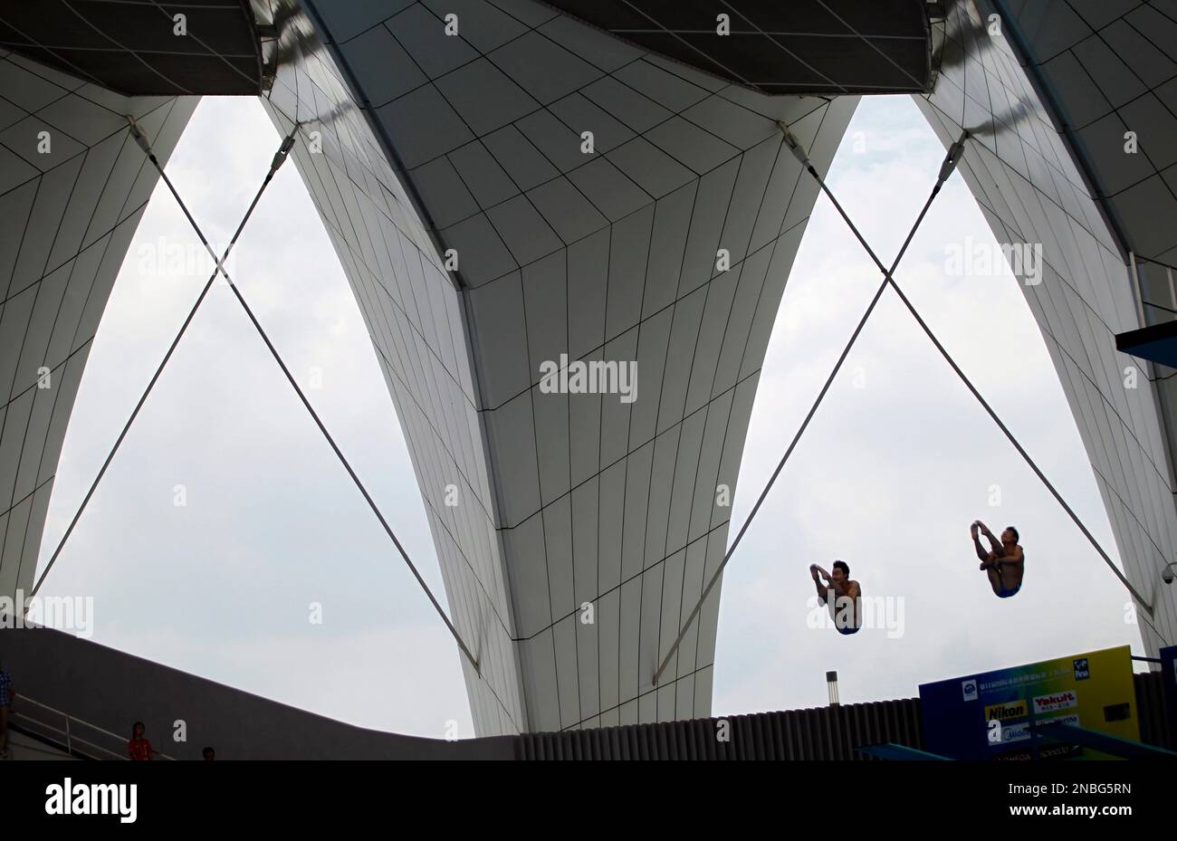 Qin Kai and Luo Yutong of China dive during the men's 3m Synchro ...