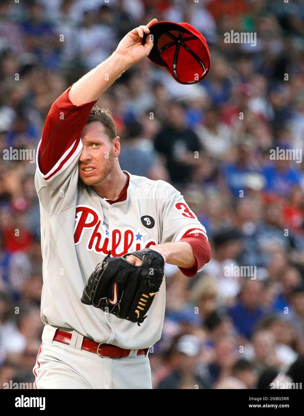 Philadelphia Phillies starting pitcher Roy Halladay wipes the sweat ...