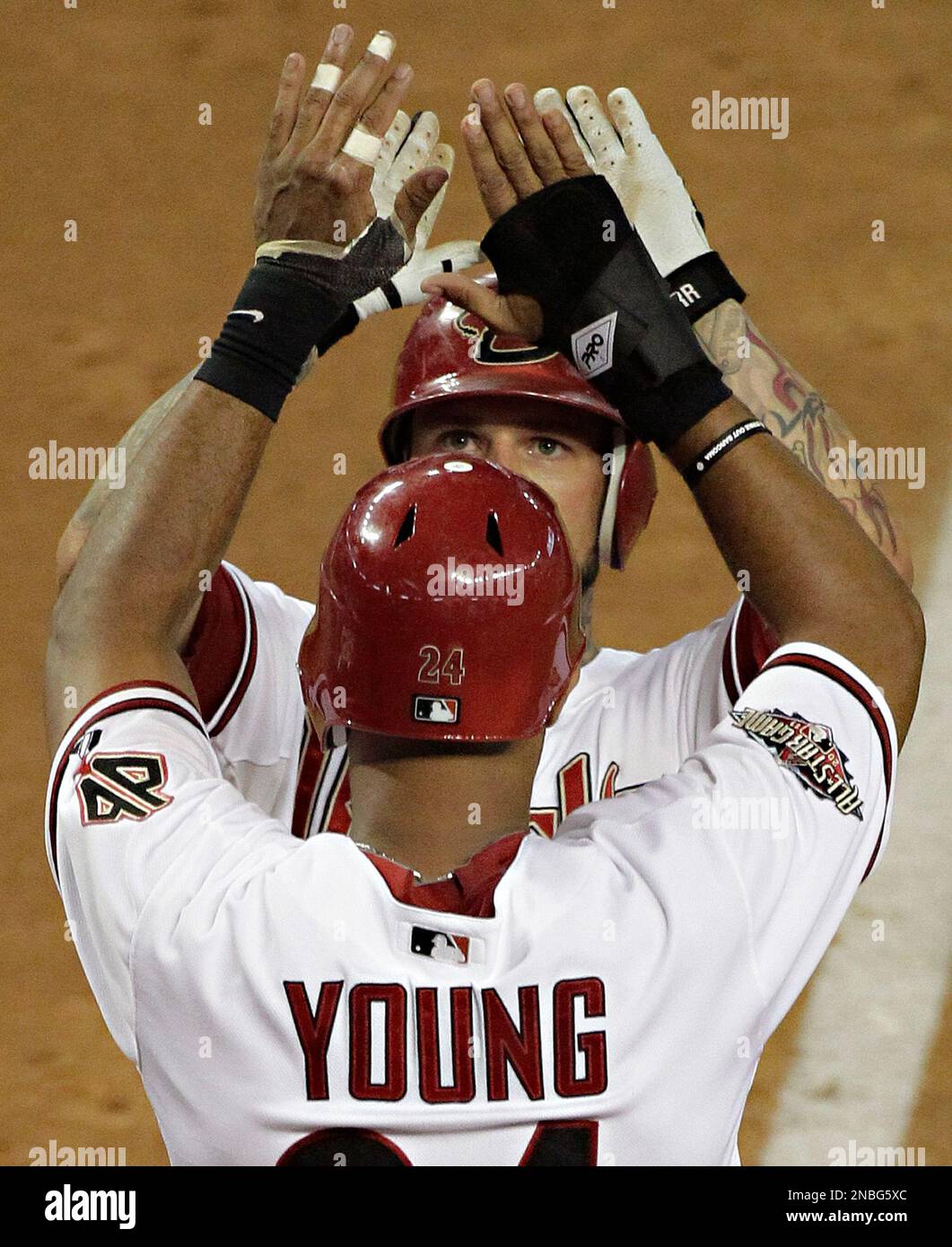 Arizona Diamondbacks' Ryan Roberts, rear, high fives teammate Chris ...