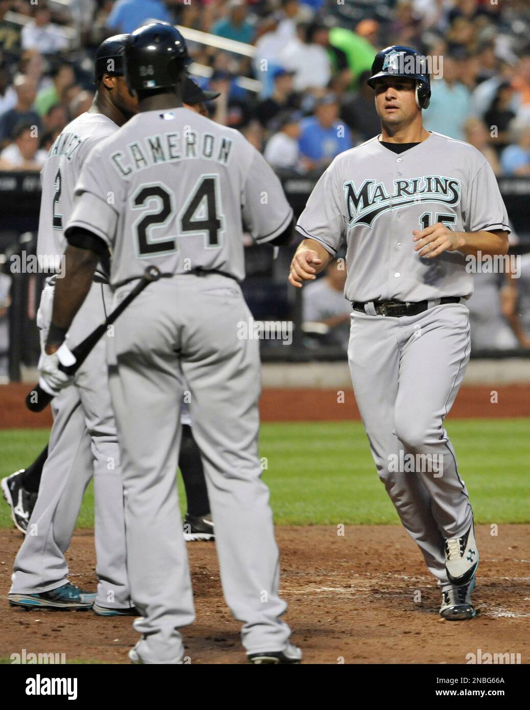 Florida Marlins' Mike Cameron (24) greets Gaby Sanchez (15) and Hanley ...