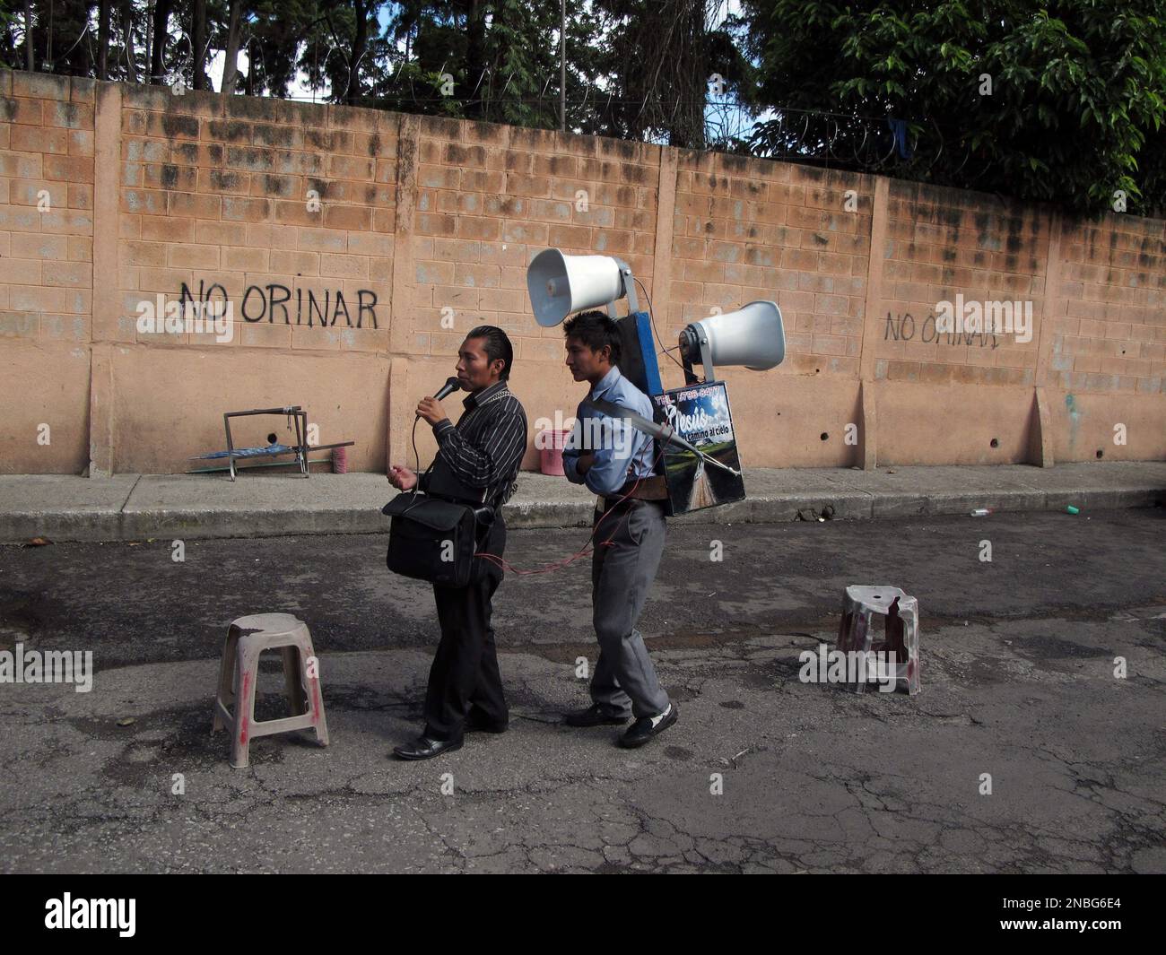 Jose Laria Pino, 24, left, preaches the Bible as his brother Gerardo ...