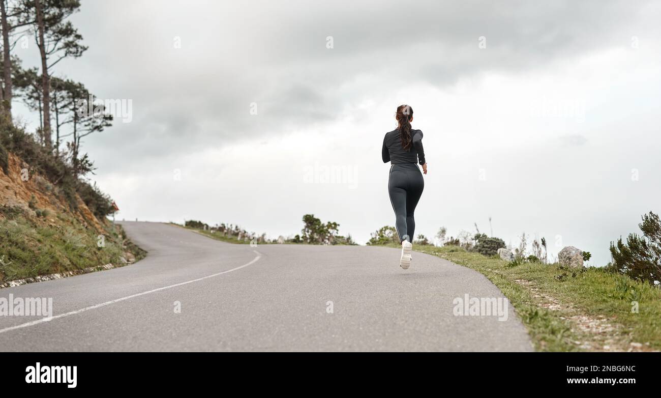 Running becomes rhythmic. Full length shot of an unrecognizable woman ...
