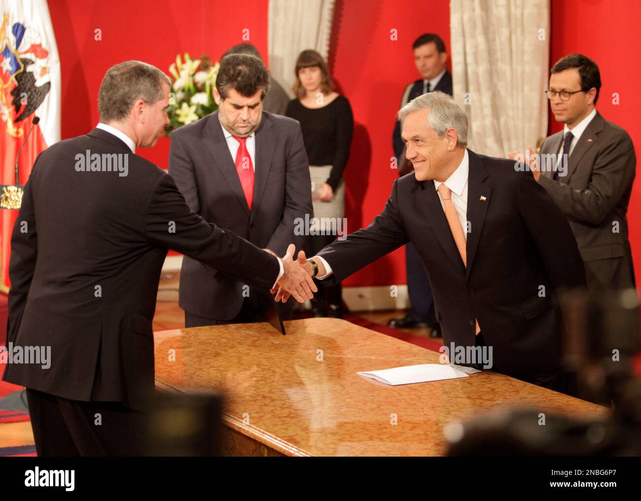 Chile's new Education Minister Felipe Bulnes, left, shakes hands with ...