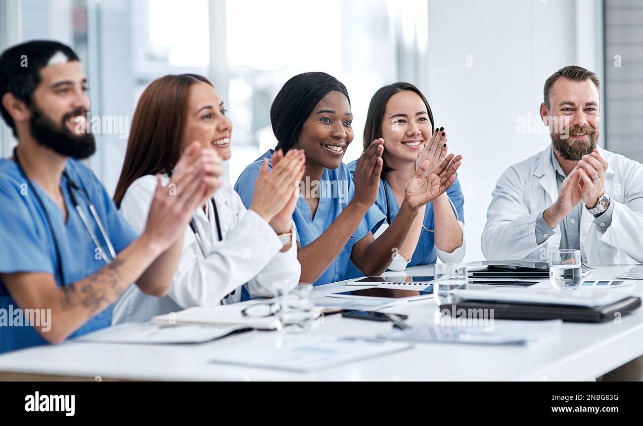 Medical team talking together applauding hi-res stock photography and ...