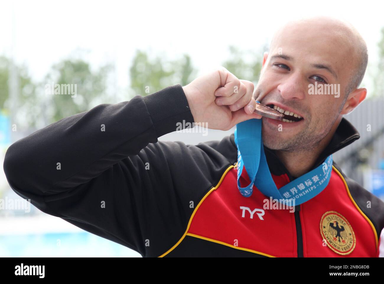 Germany's Pavlo Rozenberg bites his bronze medal following the men's 1 ...