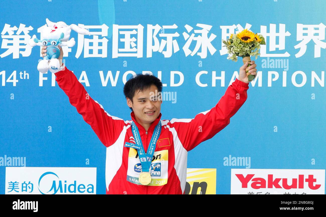 China's Li Shixin waves from the podium as he celebrates his win in the ...