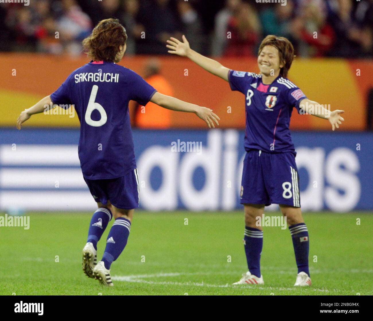 Japan's Mizuho Sakaguchi and Japan's Aya Miyama celebrate during the final match between Japan ...
