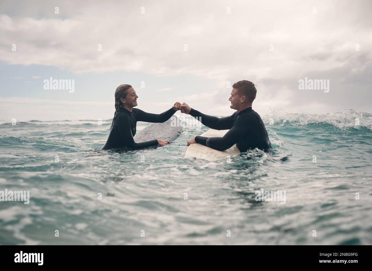 We caught feelings while catching some waves. a young couple out ...