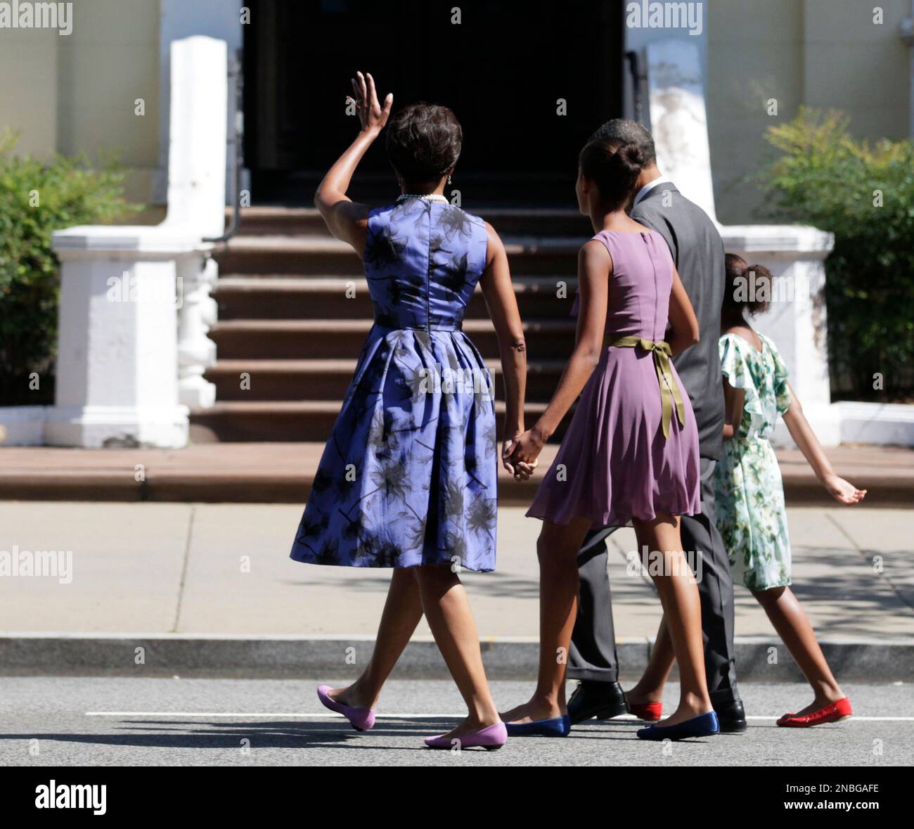 President Barack Obama walks with his family, first lady Michelle Obama ...