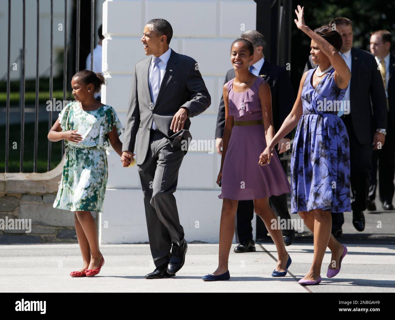 President Barack Obama walks with his family, first lady Michelle Obama ...