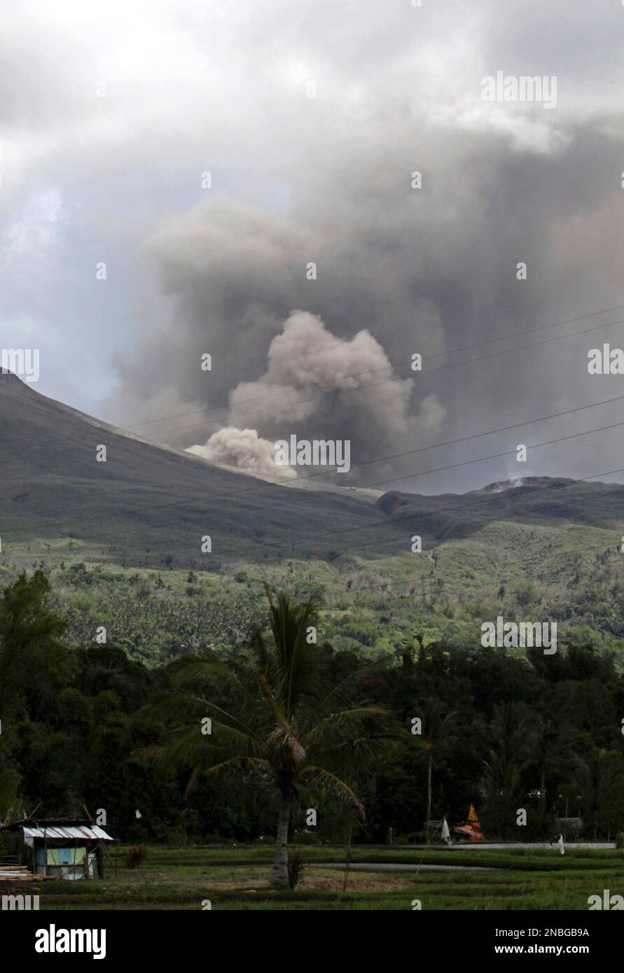 Mount Lokon spews volcanic ash as seen from Tomohon, North Sulawesi ...