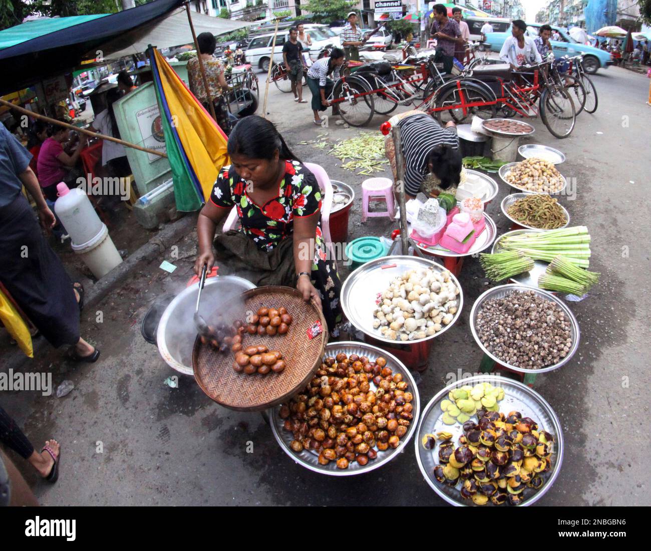 In this photo taken Saturday, July. 16, 2011, a vendor sells food at a ...