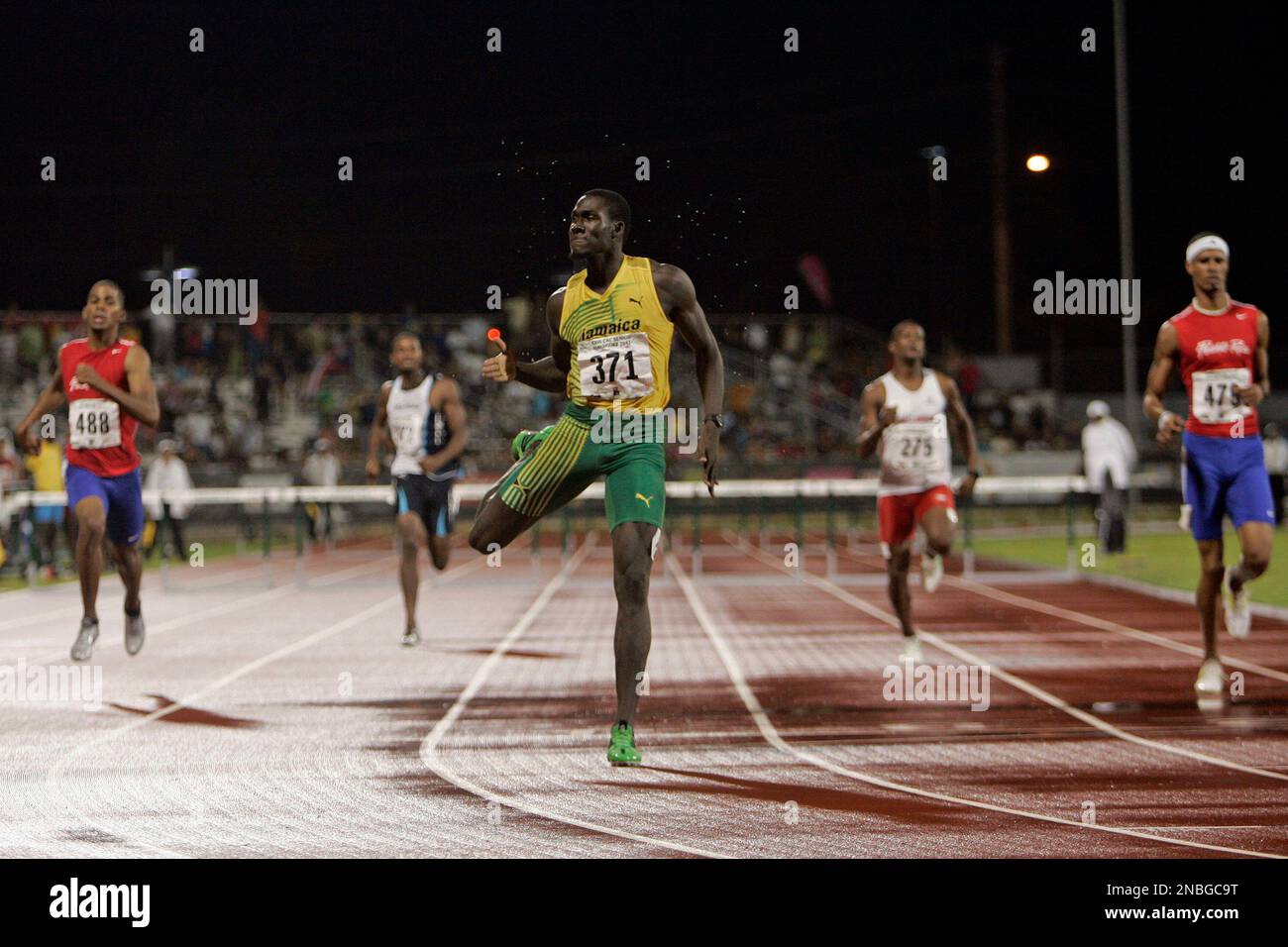 Jamaica’s Leford Green, center, crosses the finish line to win the men ...