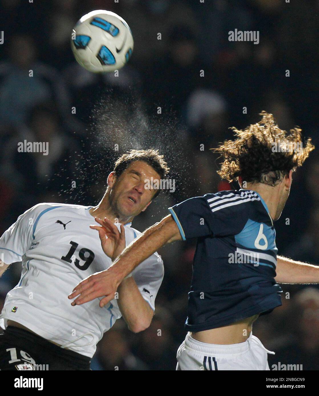 Uruguay's Andres Scotti, left, and Argentina's Gabriel Milito go for a ...