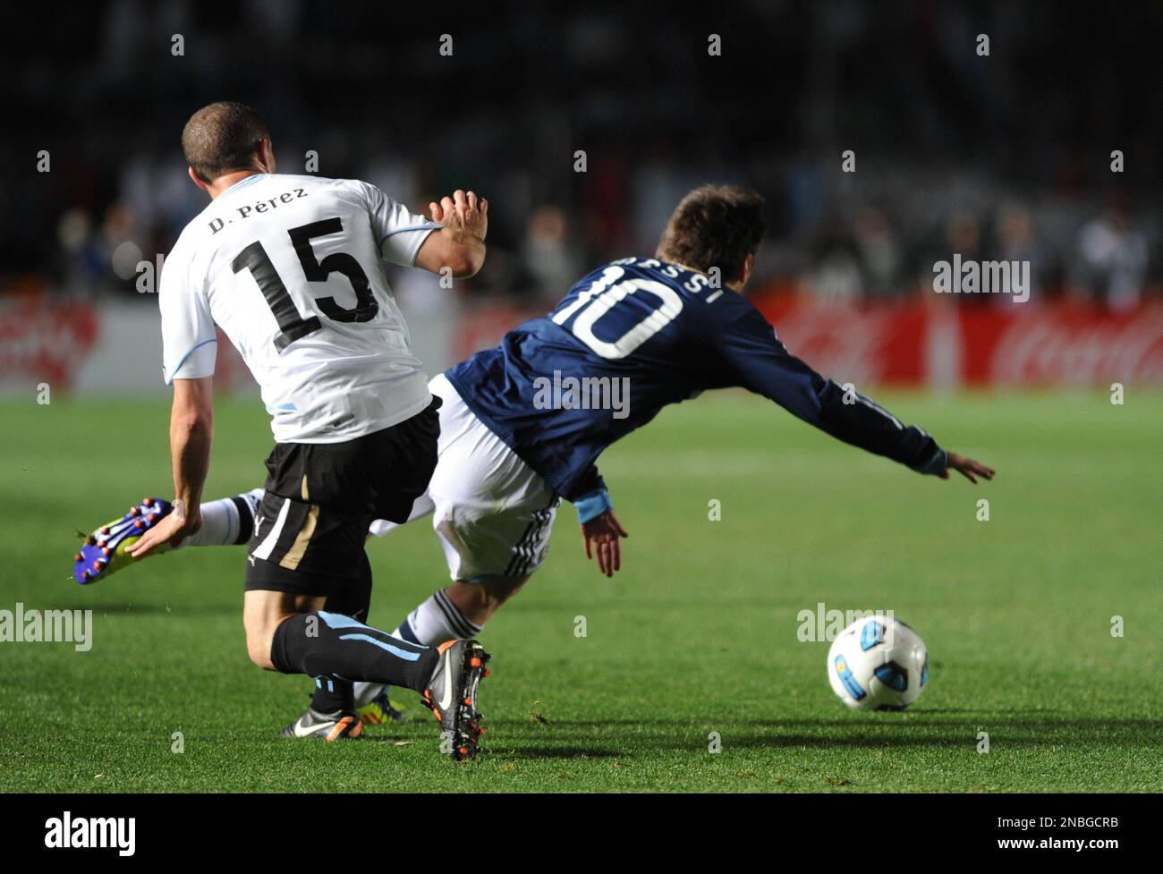 Argentina's Lionel Messi, right, is fouled by Uruguay's Diego Perez ...