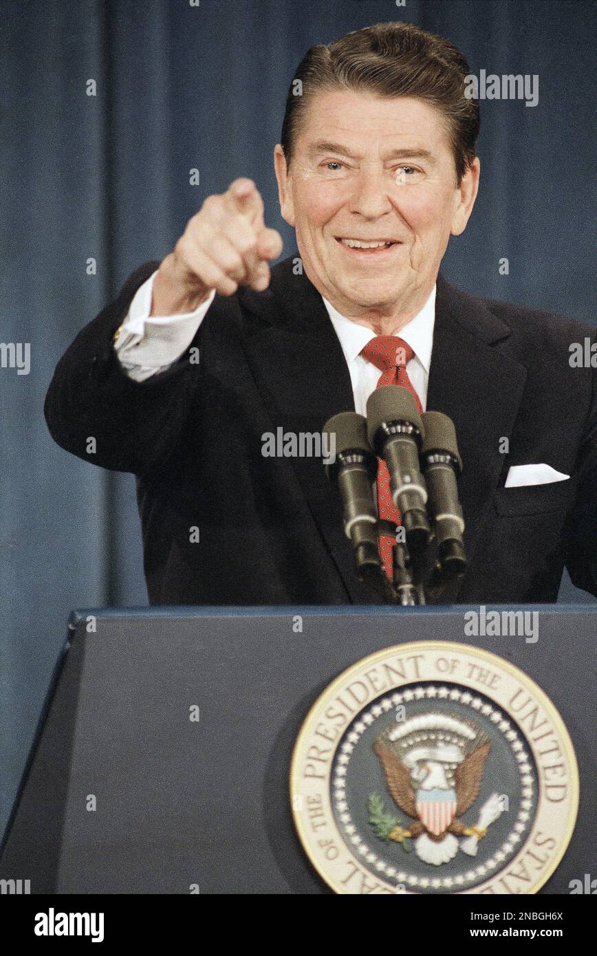 President Ronald Reagan gestures to reporters during a news conference ...