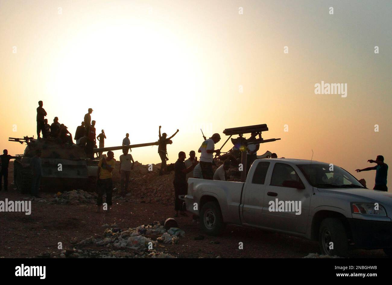 In this Thursday, July 14, 2011 photo, Libyan rebels gather around a ...