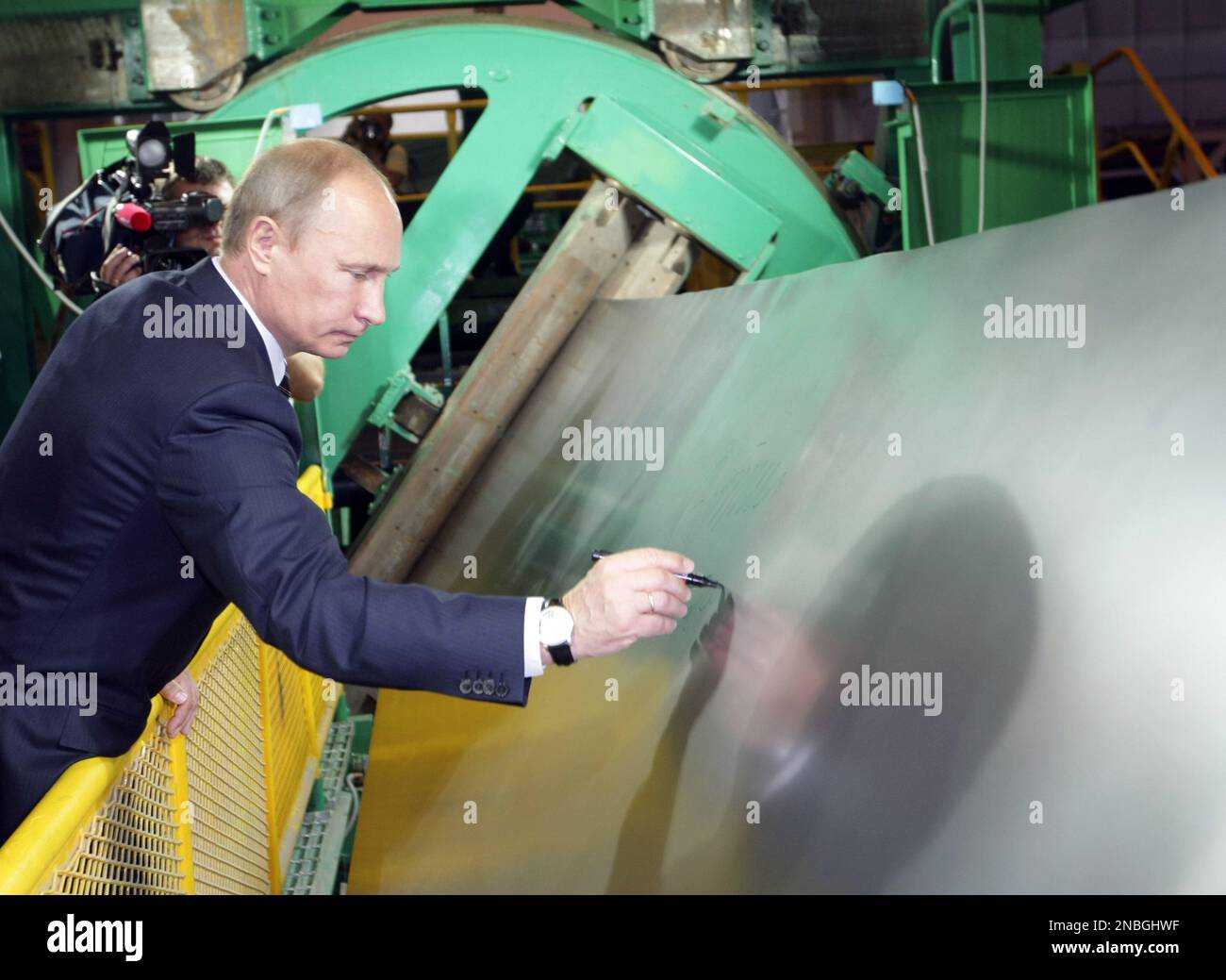 Russian Prime Minister Vladimir Putin signs an autograph during a visit ...