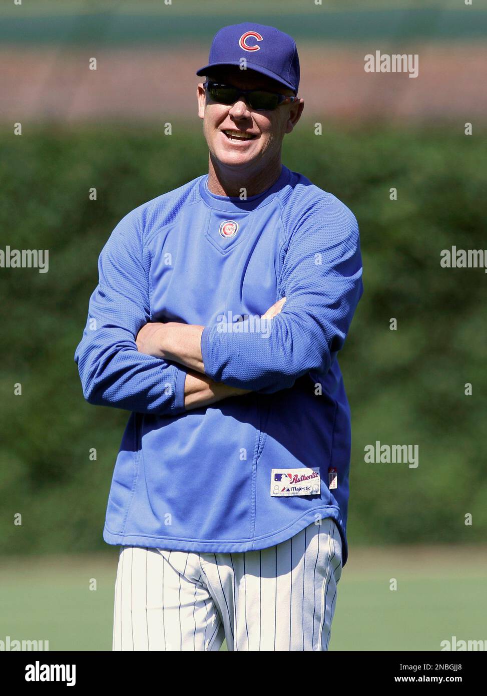 Chicago Cubs manager Mike Quade smiles on the field before a baseball ...