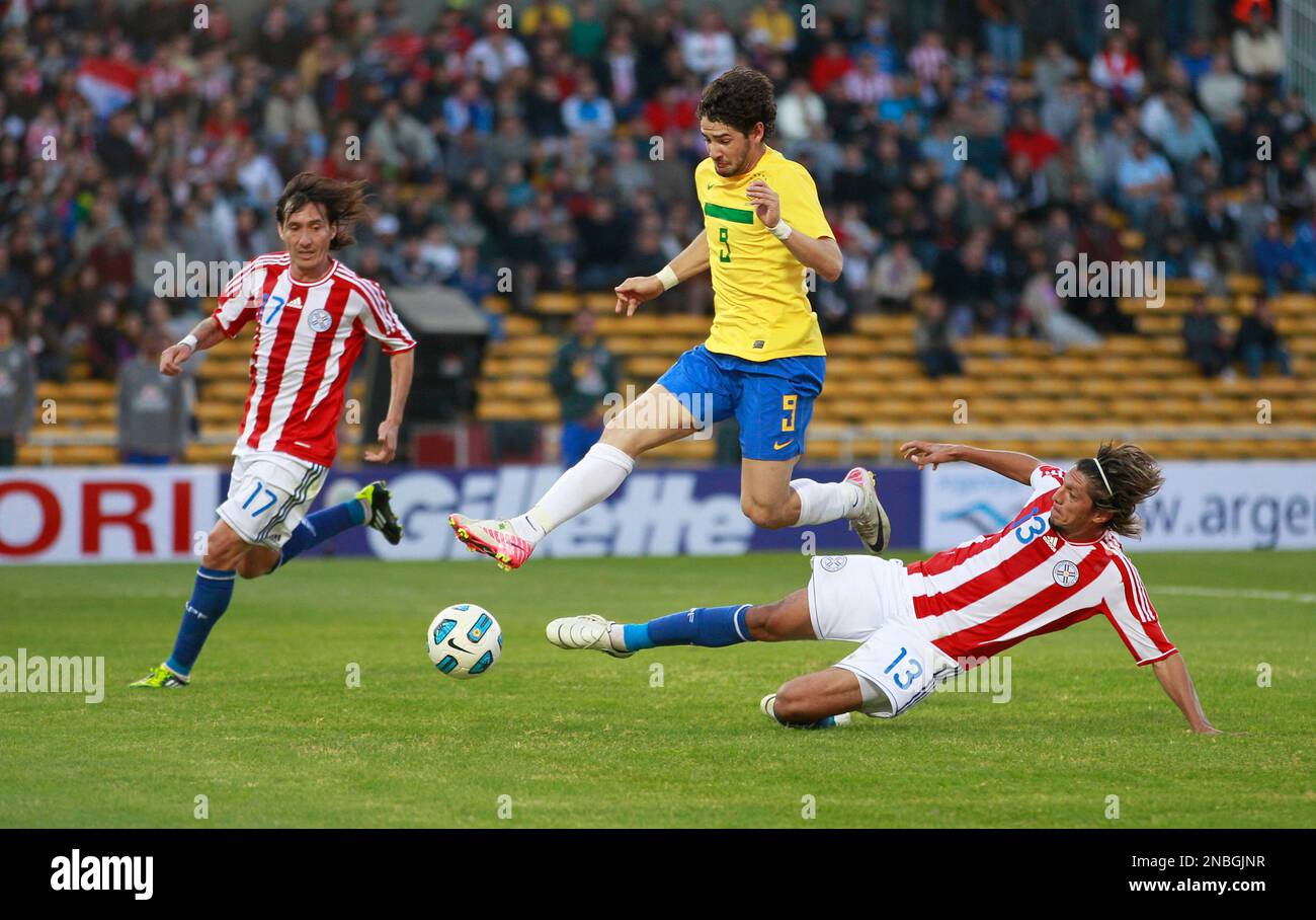 Brazil's Alexandre Pato fights for the ball with Paraguay's Enrique ...