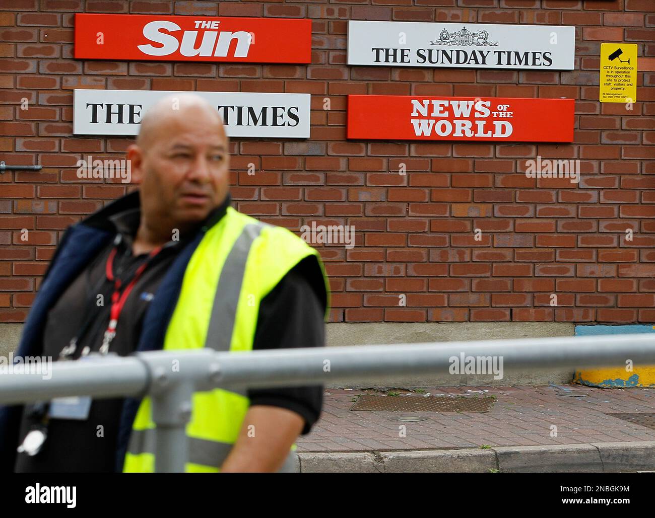 A security guard keeps watch at News International in Wapping, London ...