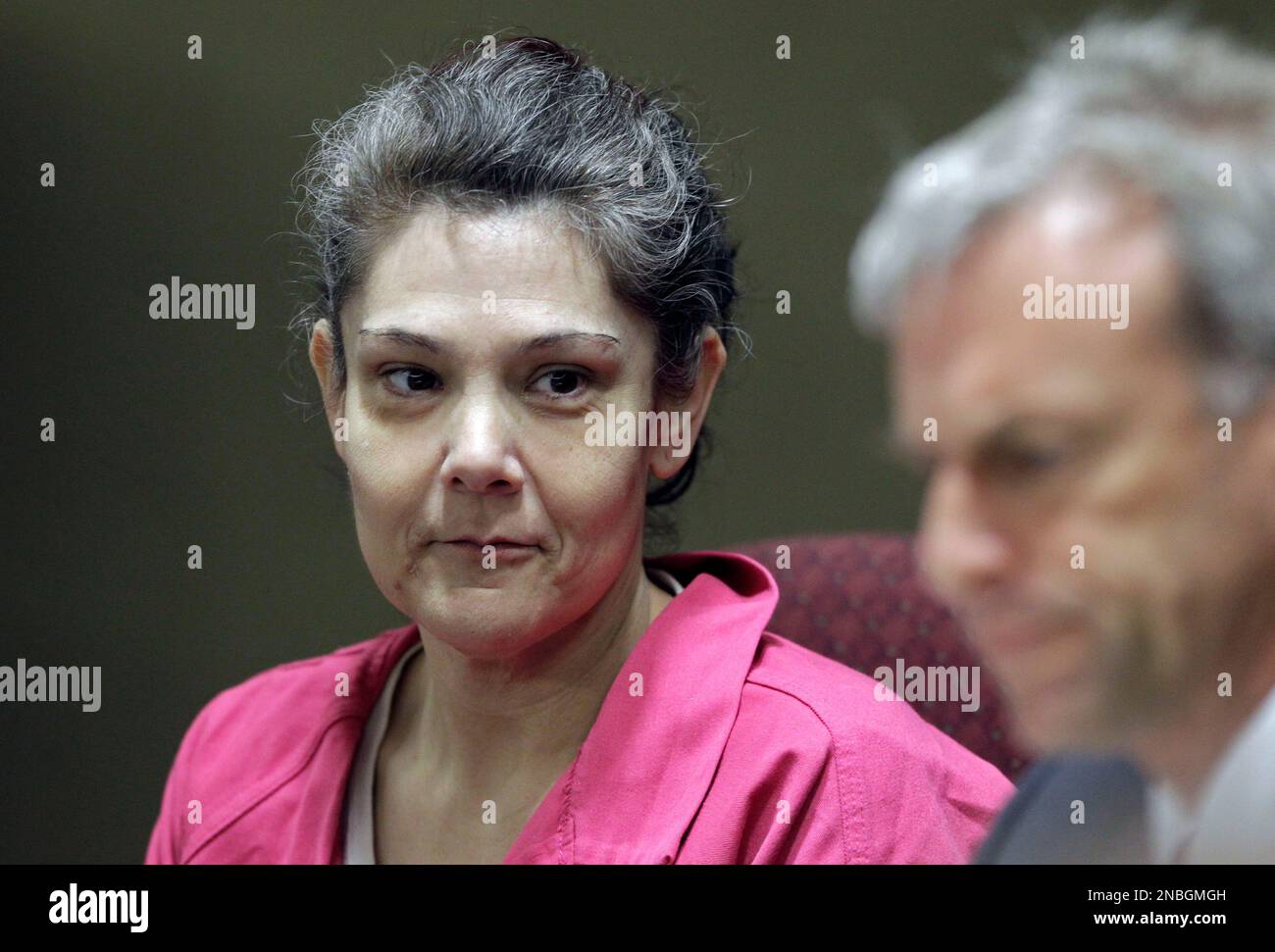 Elisa Baker, left, smiles as she turns to attorney Scott Reilly, right ...