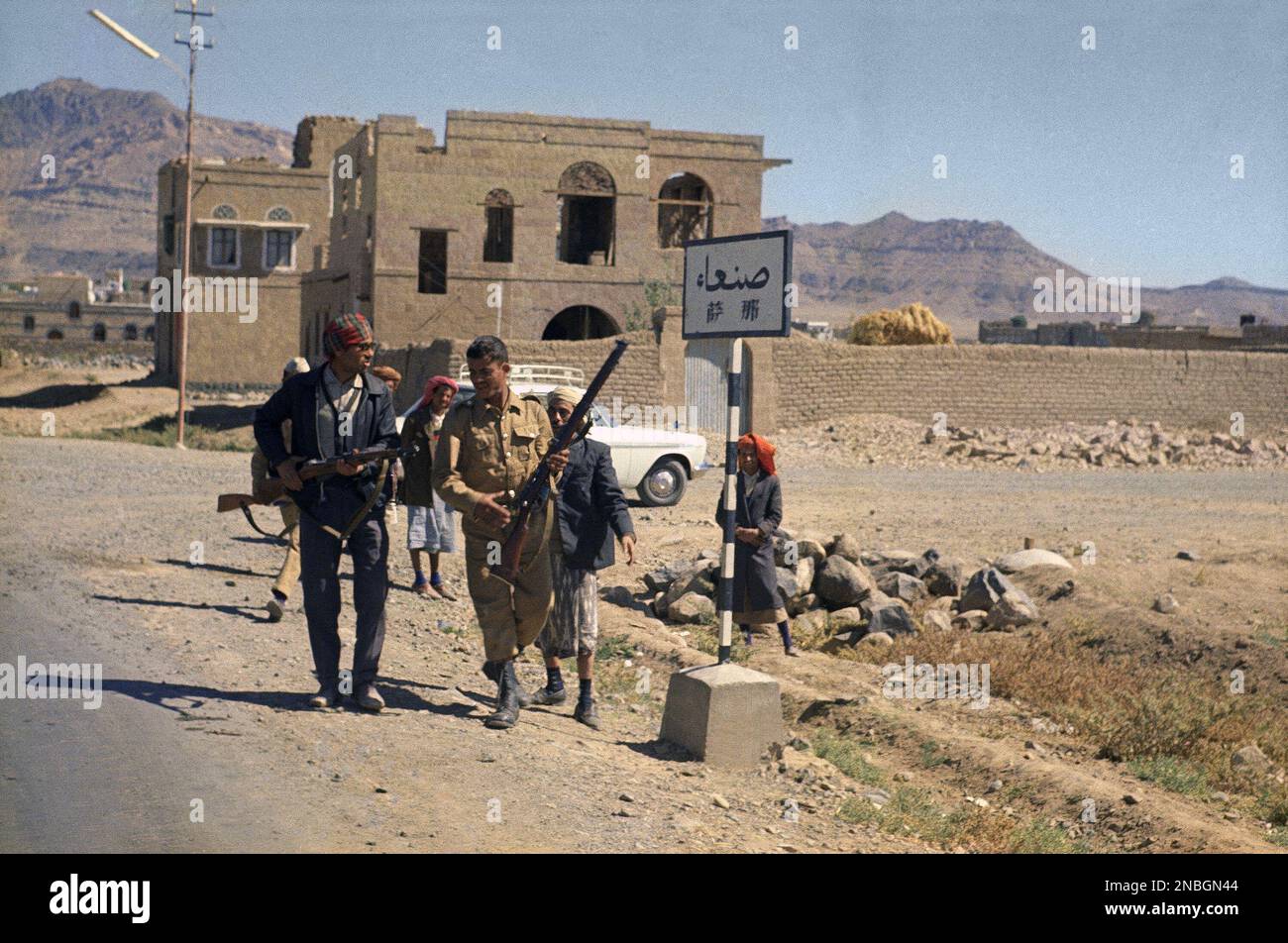 Local men in Yemen marching with rifles on the Sana’a-Hodeida main ...
