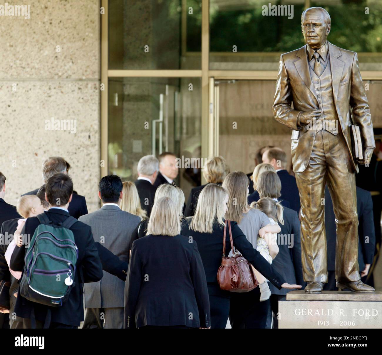 Members of the Ford family walk past the statue of the former President ...