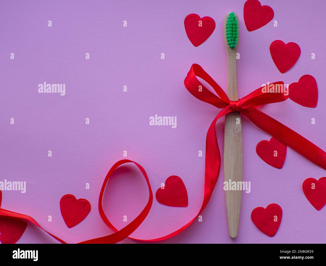 Flat lay with a lot of tiny heart-shaped papers, toothbrush and space ...