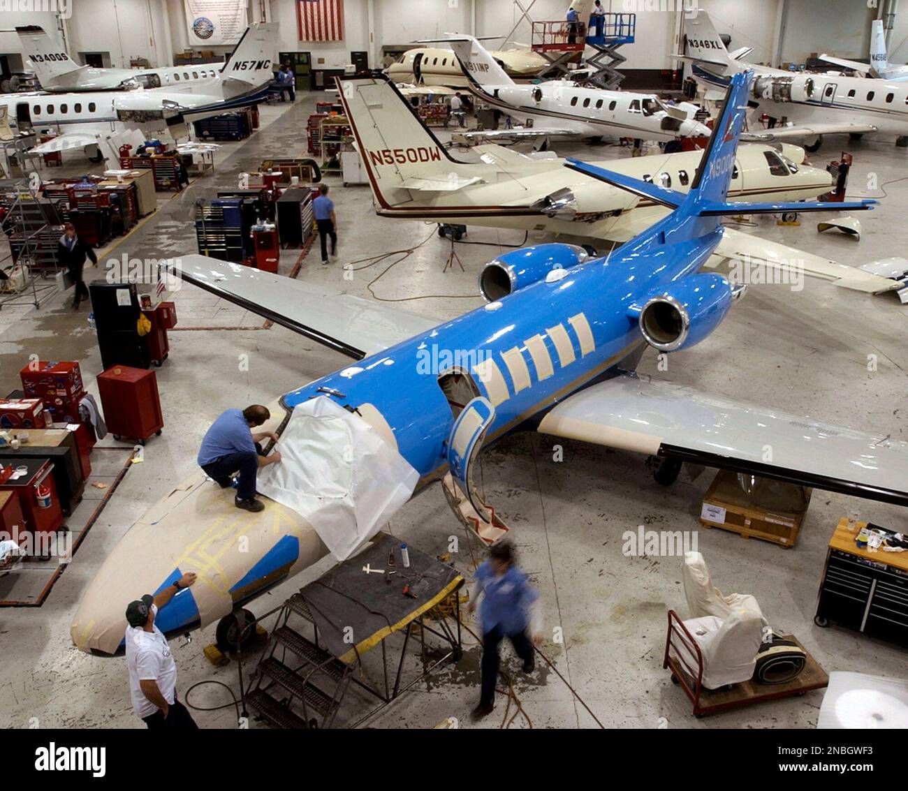 FILE - In this Nov. 4, 2004 file photo, workers service Cessna Citation ...