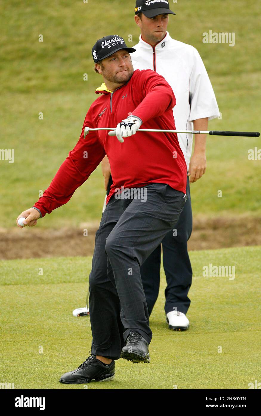Steve Marino of the U.S. prepares to throw a golf ball on the 6th green ...