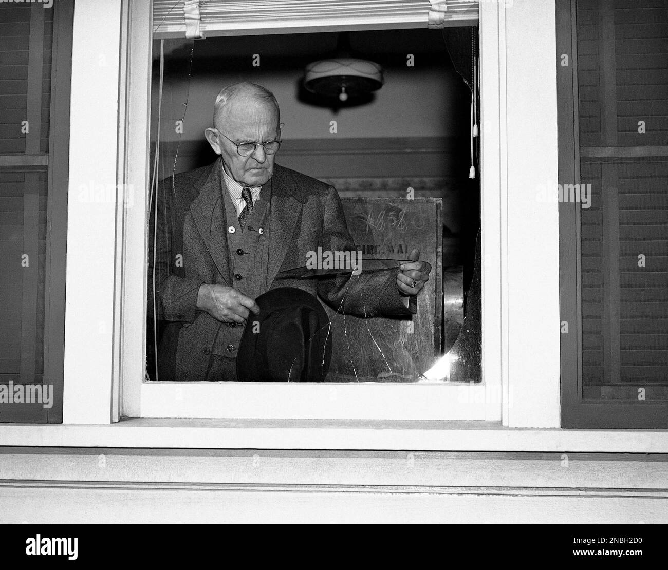H.G. Landis stands in the window cracked by anti-aircraft firing, Feb ...