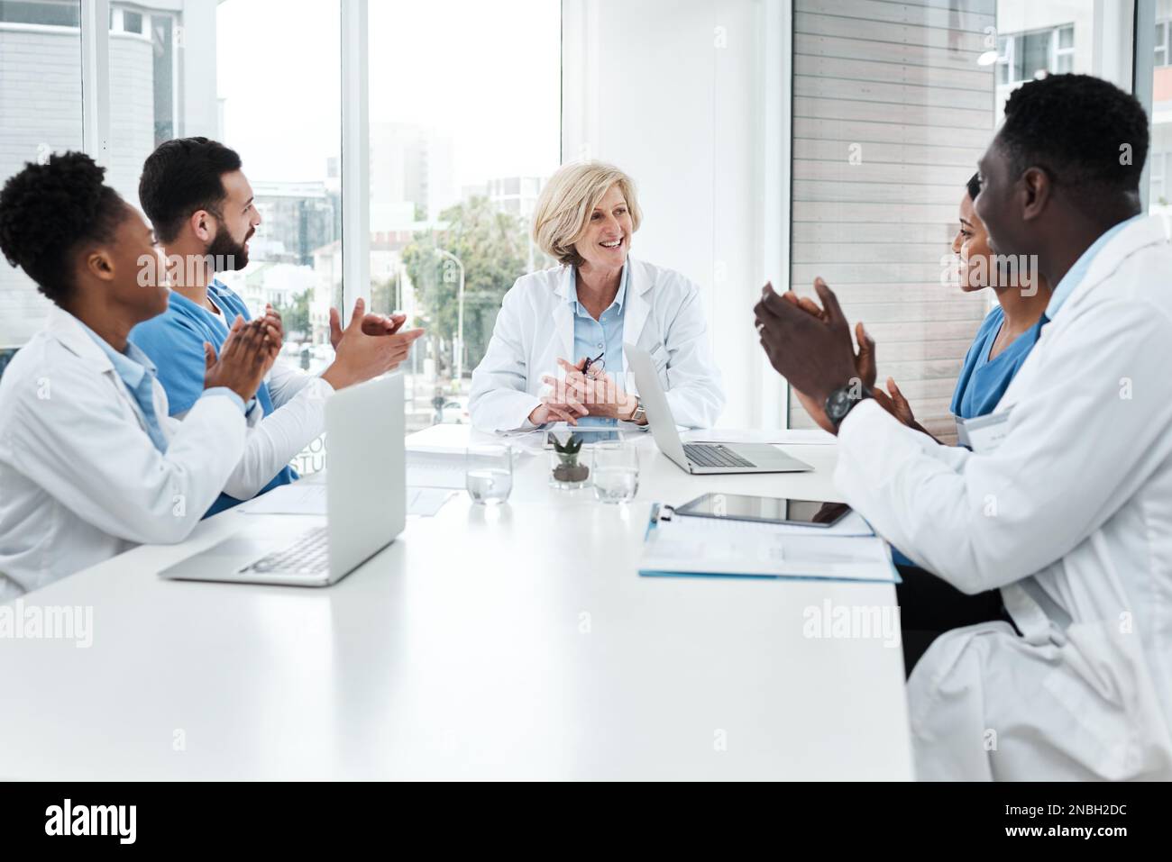 Medical team talking together applauding hi-res stock photography and ...