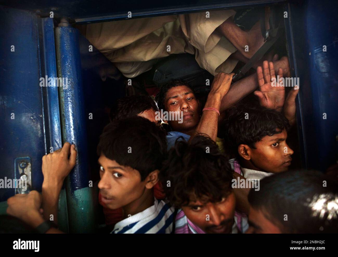 Indian train passengers crowd into an over-packed train traveling to ...