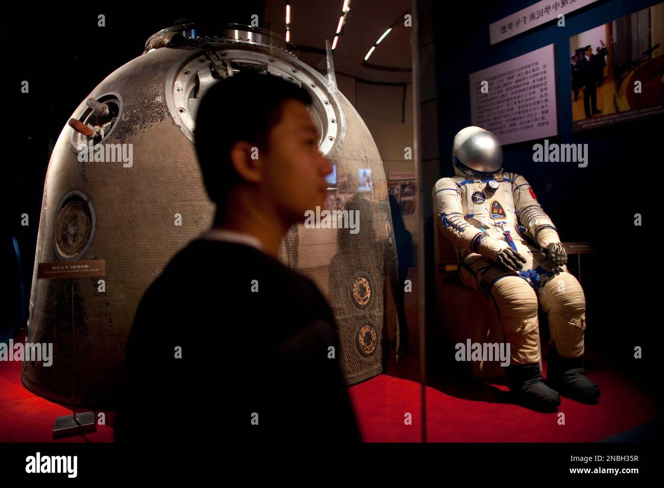 In this July 6, 2011 photo, a visitor stands near the Shenzhou 5 re ...