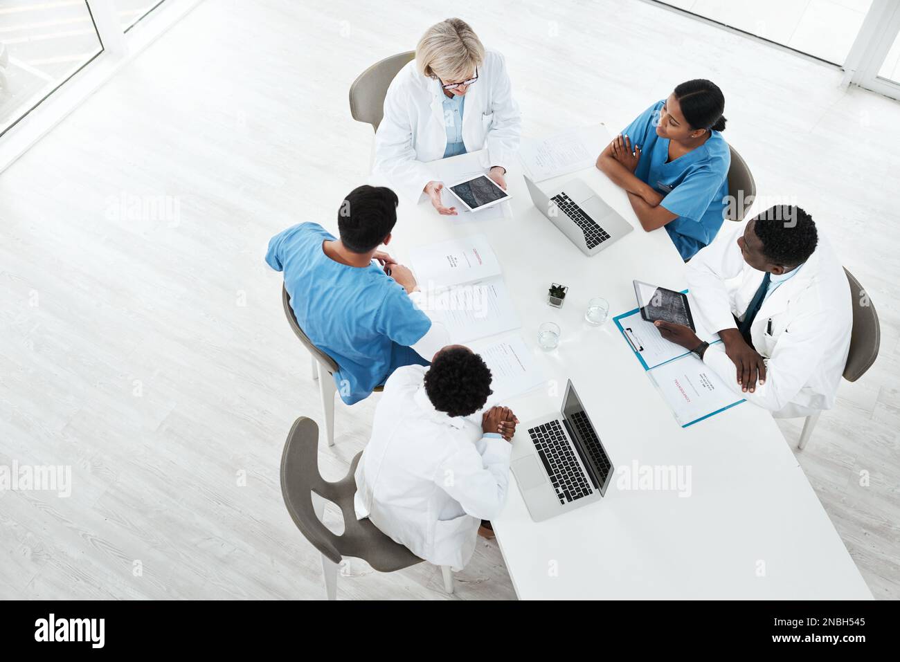 Coordinating their tasks as a team. High angle shot of a group of ...