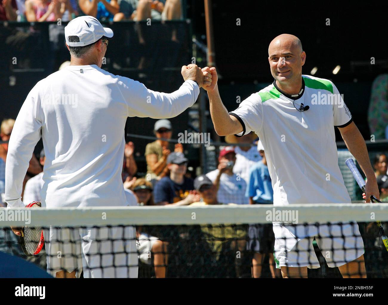 Tennis great Andre Agassi reacts with his former coach Brad Gilbert ...