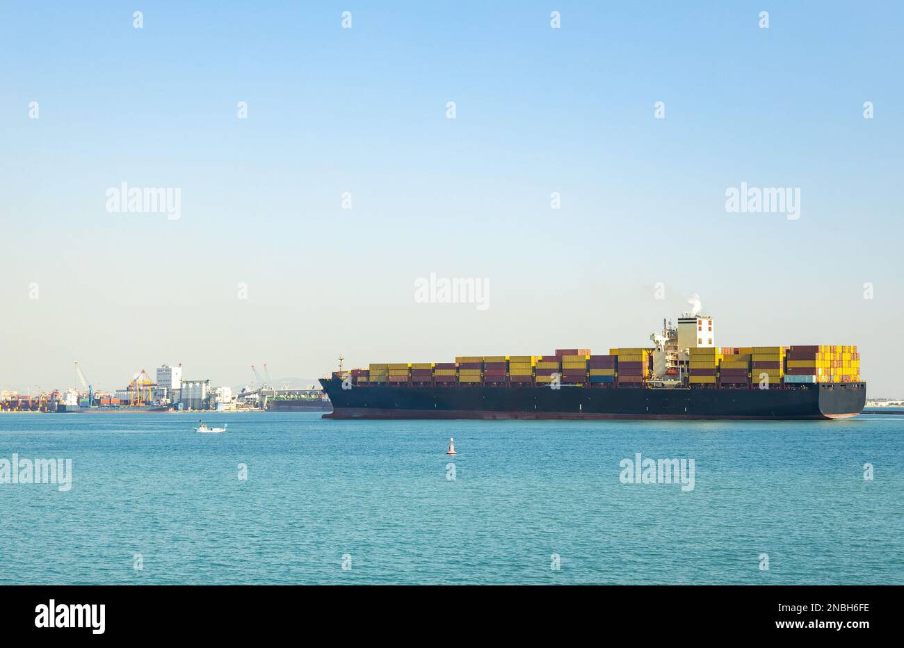 Large cargo container ship sails in the seaport Stock Photo - Alamy