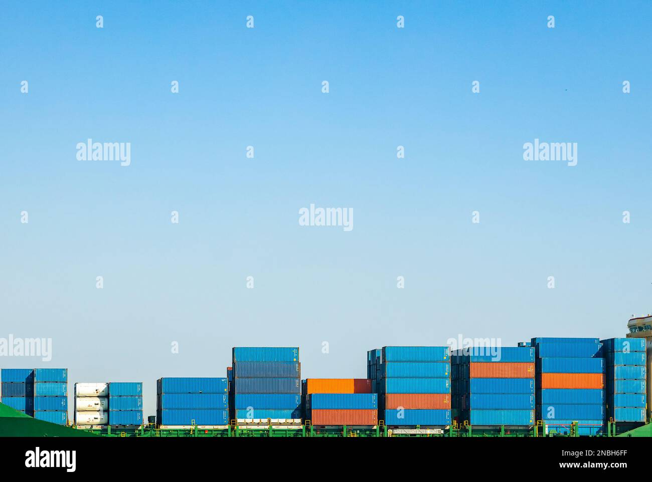 A large cargo container ship loaded with containers against the blue ...