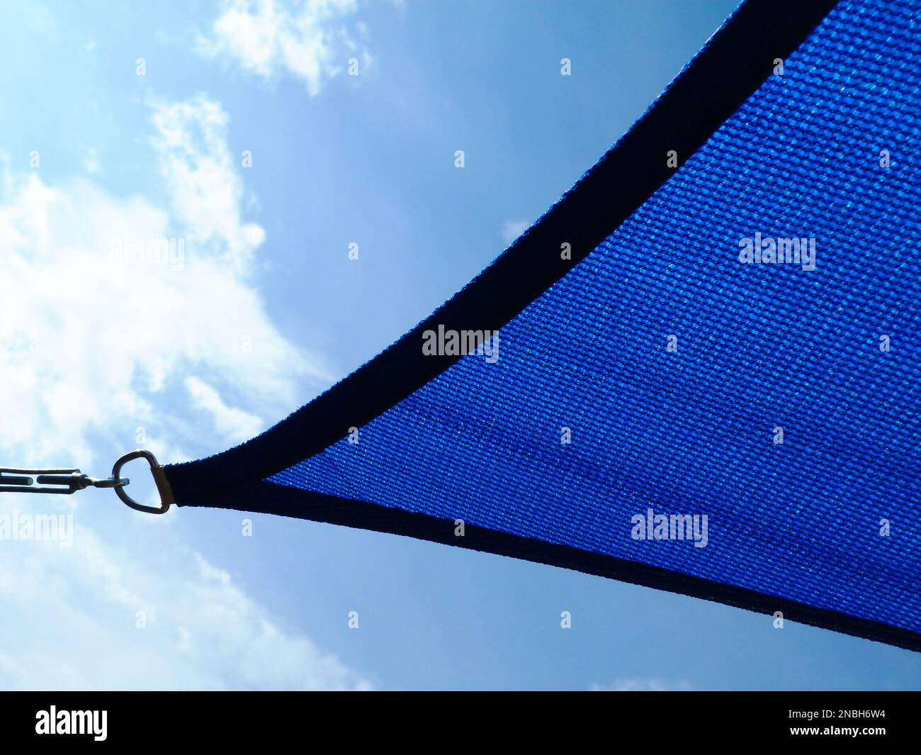 suspended fabric awning and shade. blue sky with clouds. sunny summer ...