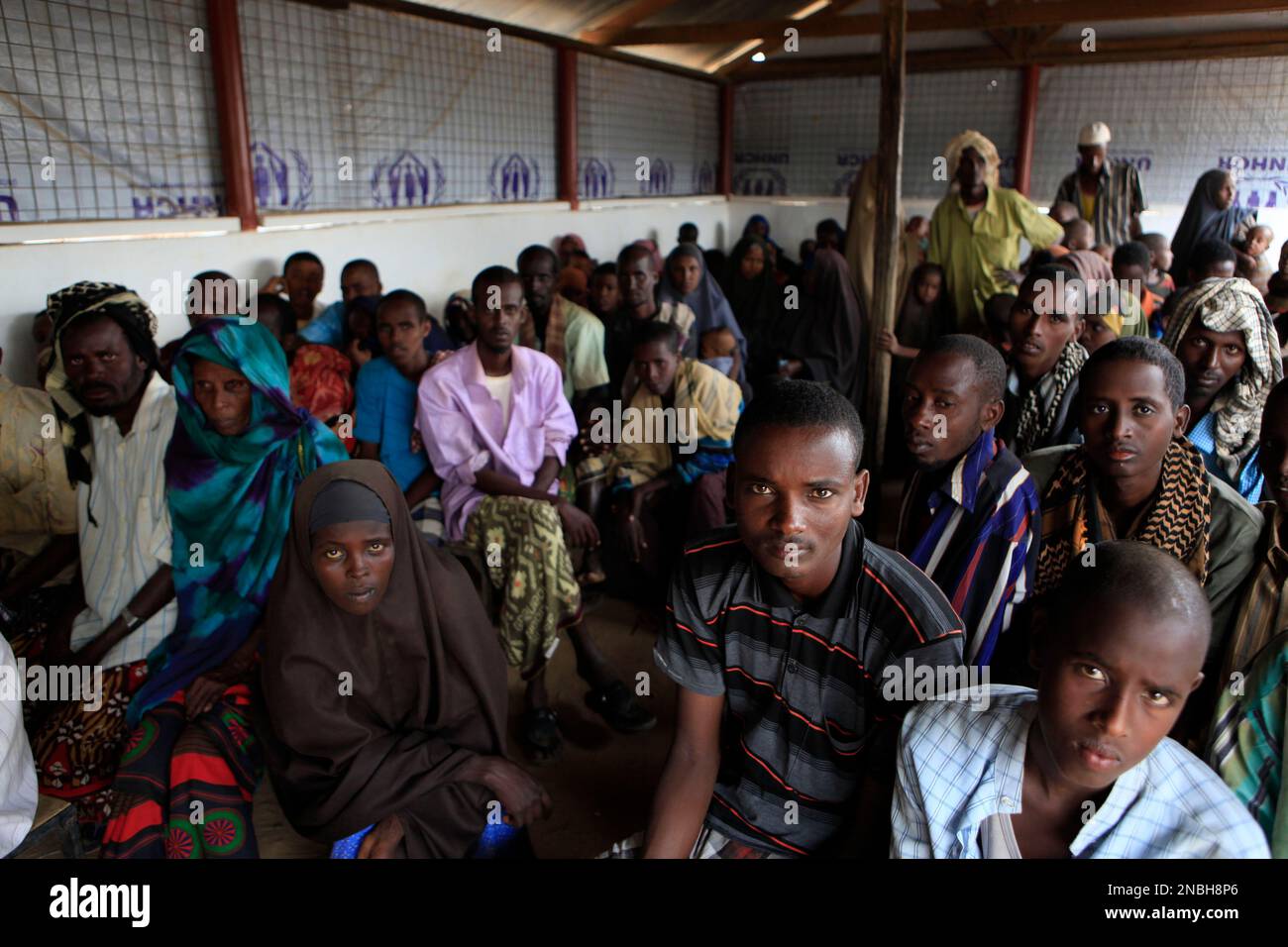 Refugees newly arrived from Somalia wait to be registered at a ...