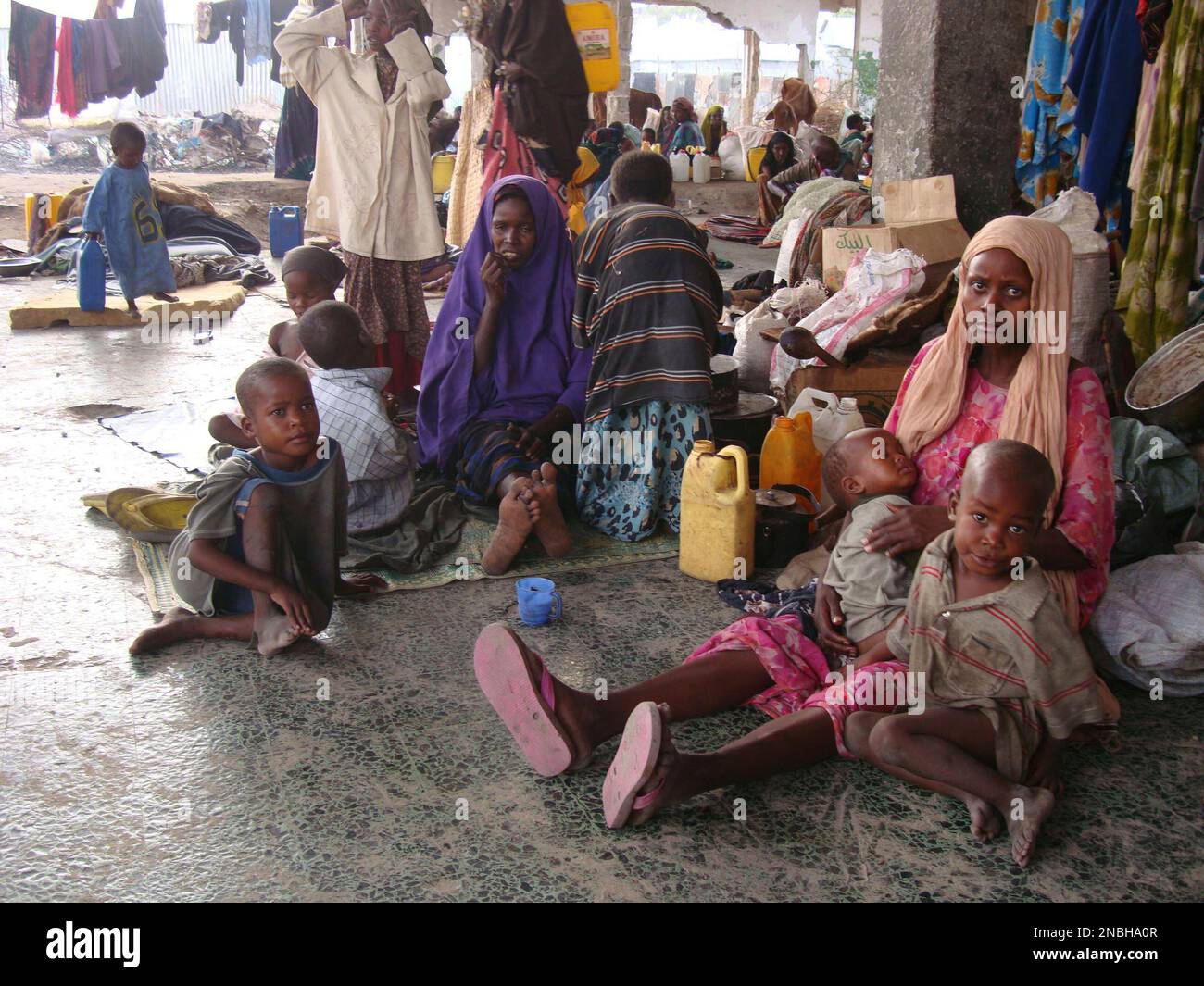 Somalis from southern Somalia wait inside a ruined building, Saturday ...