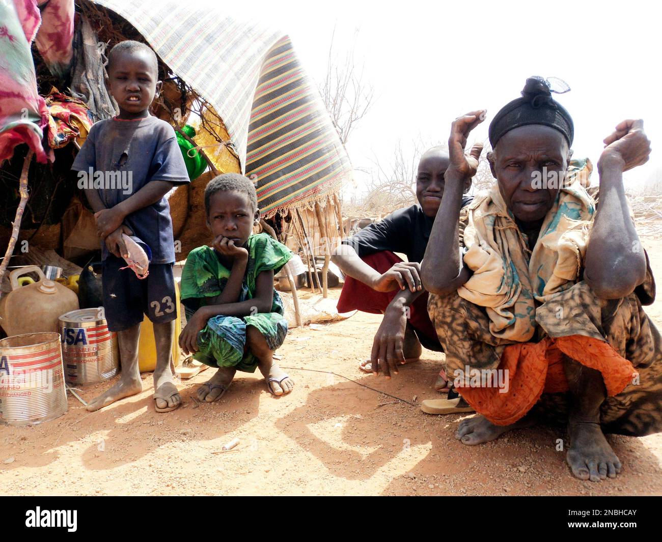 Refugees sit outside in an open area as there is lack of tents at the ...