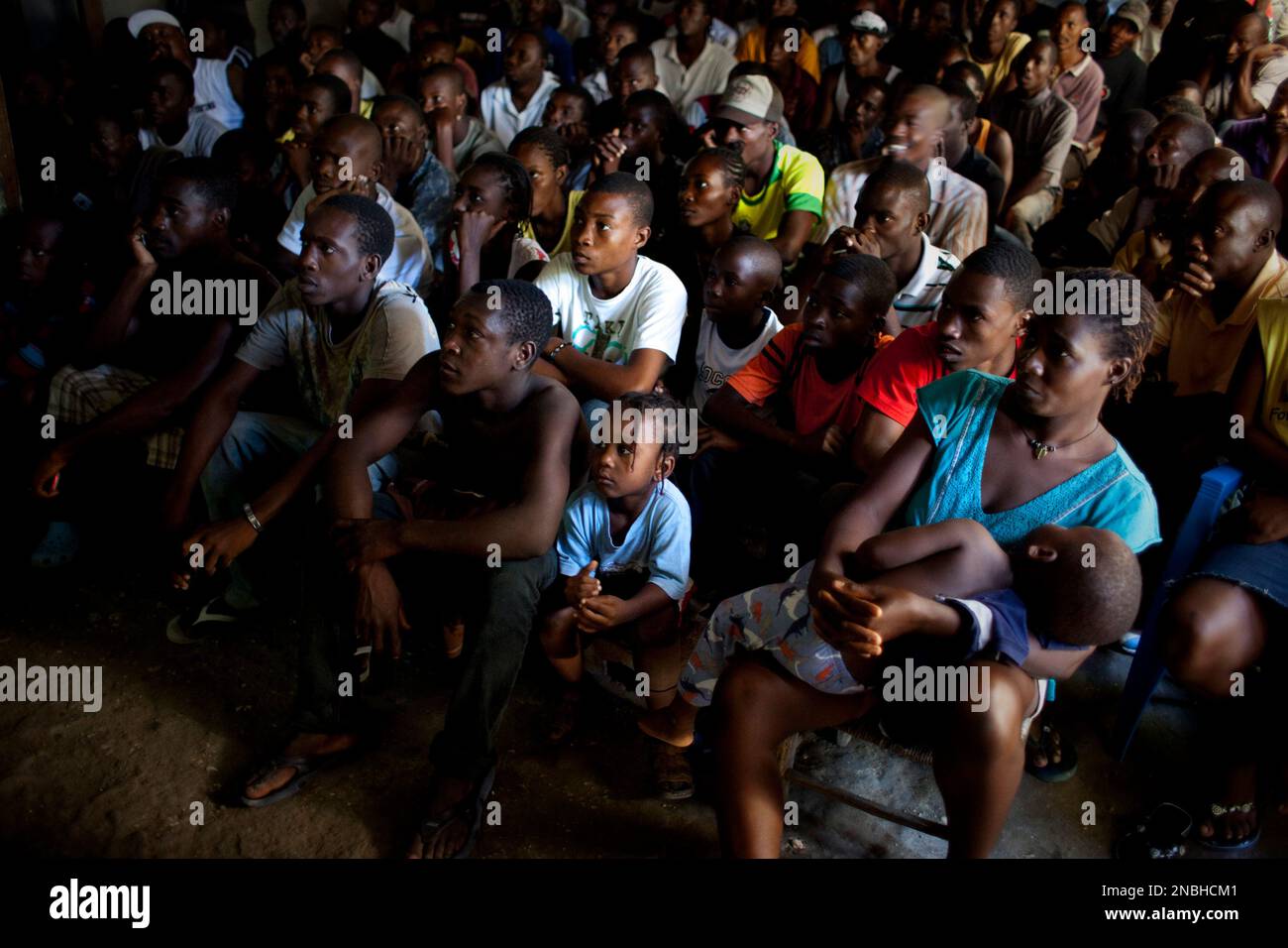 Four-year-old Schneily Similien watches the TV in a bar next to their ...