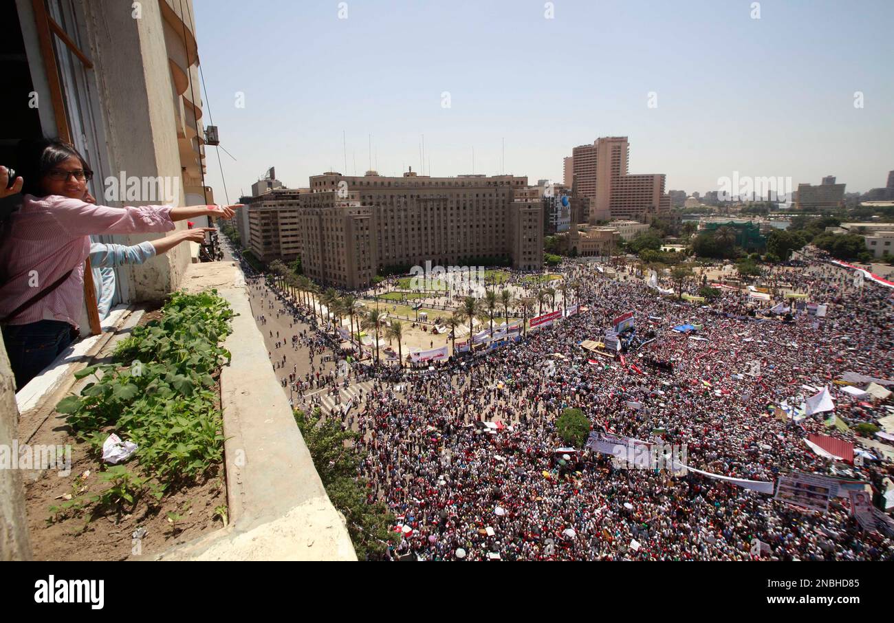 Egyptian watch thousands of Egyptians gathering at Tahrir Square, the ...