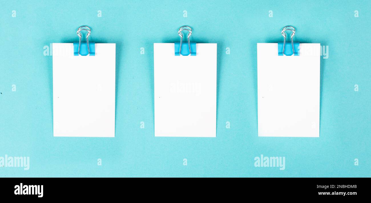 Blank white paper with a paperclip, reminder or message in the office ...