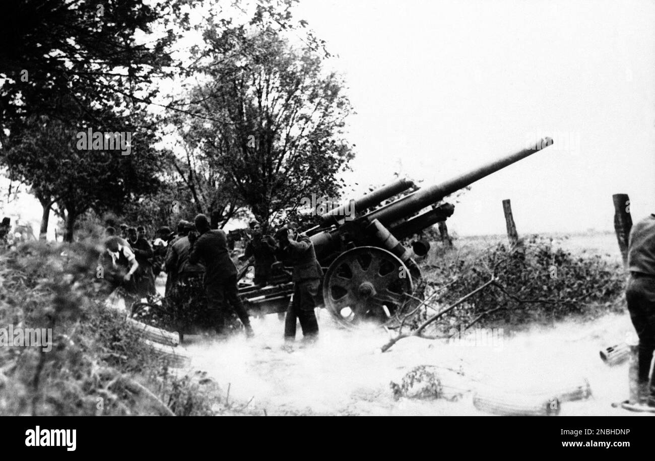 A German gun crew somewhere in France holding their ears while a field ...
