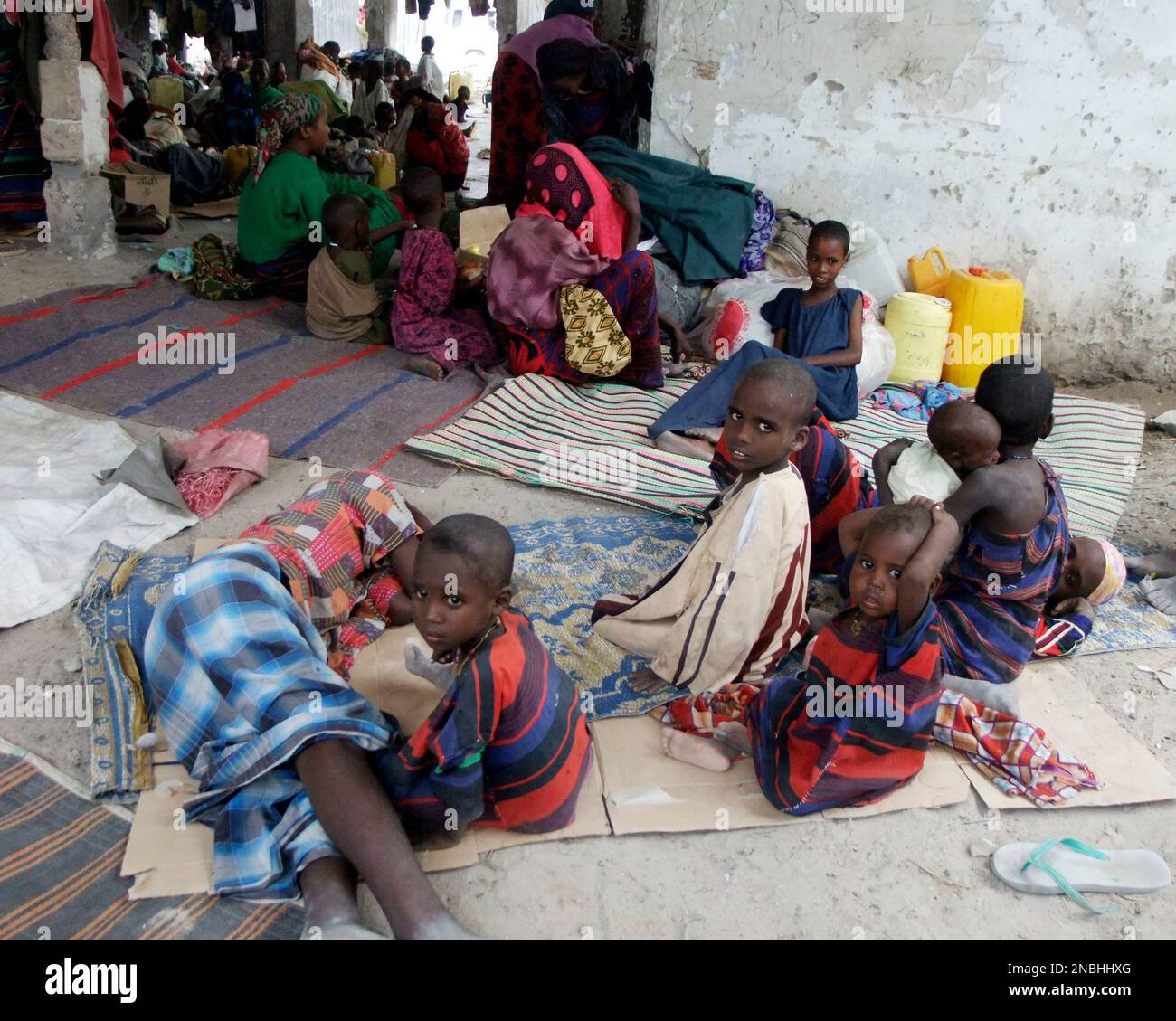 Somalis from southern Somalia with their belongings wait inside a ...