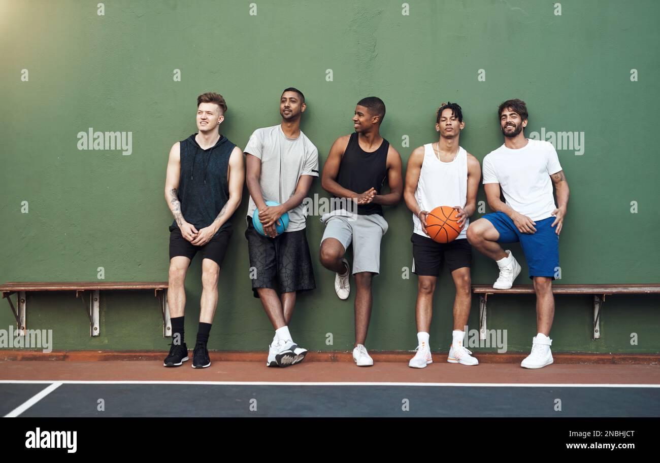 Keep calm and keep ballin. a group of sporty young men hanging out on a ...